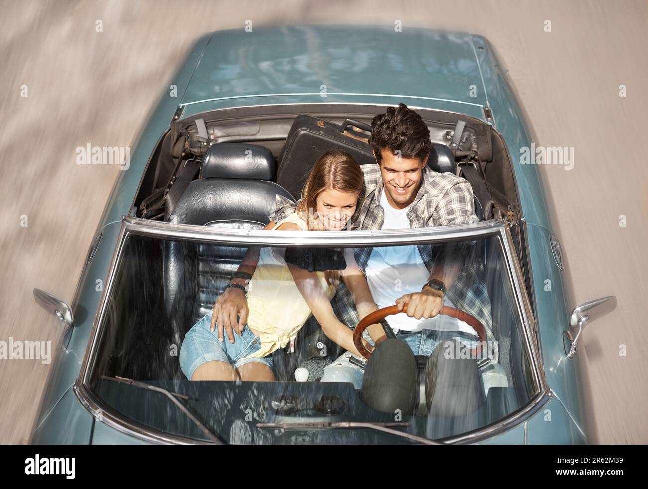Driving together. High angle view of an attractive couple traveling ...