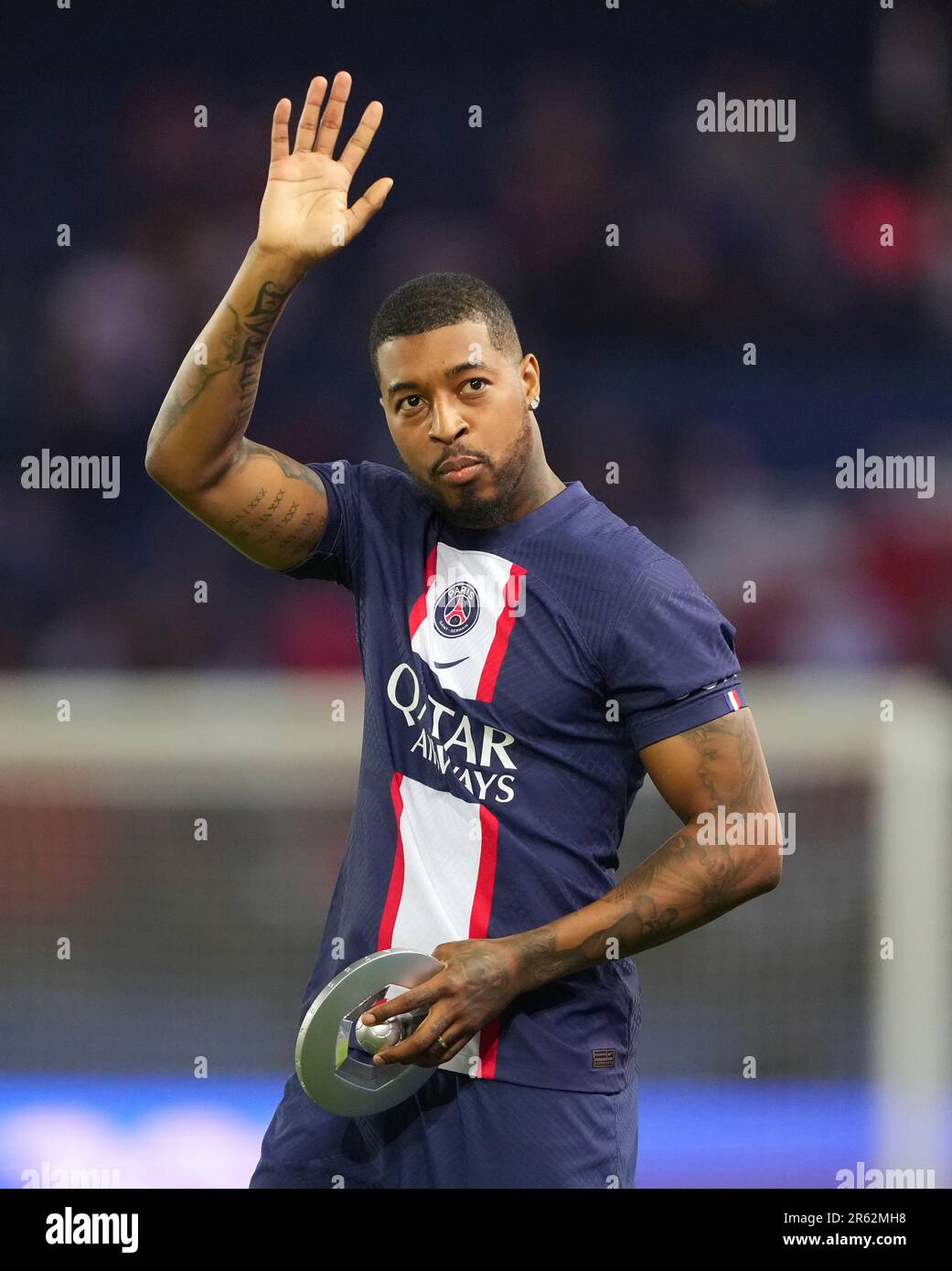 Presnel Kimpembe of PSG with a league winners trophy following ...