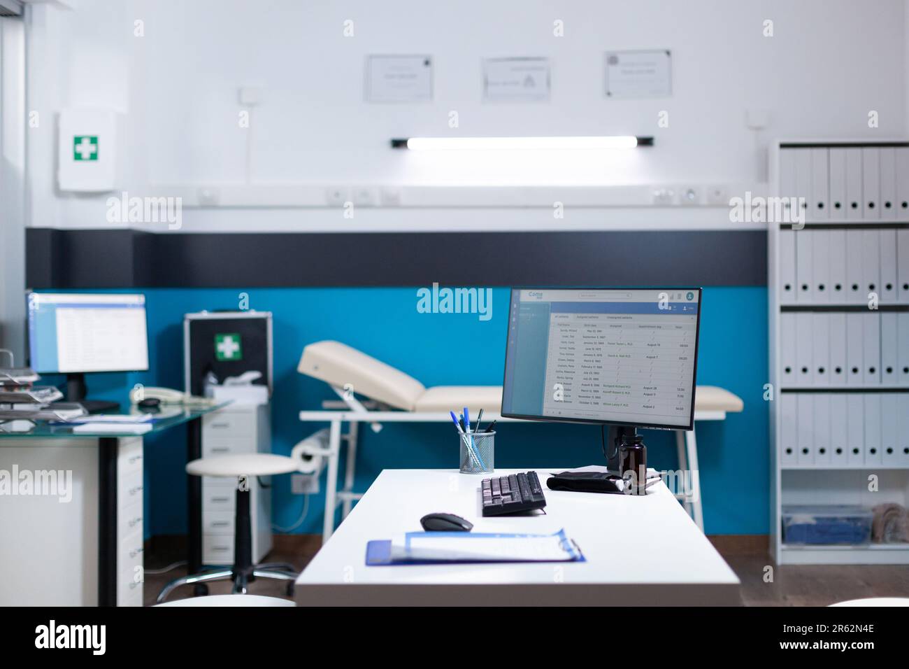 Empty healthcare medical office, no people in modern hospital interior. Computer on desk with ...