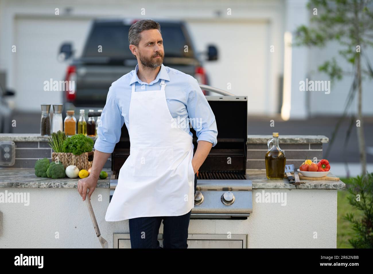 photo of cook man at bbq and grill in apron, banner. cook man at bbq ...