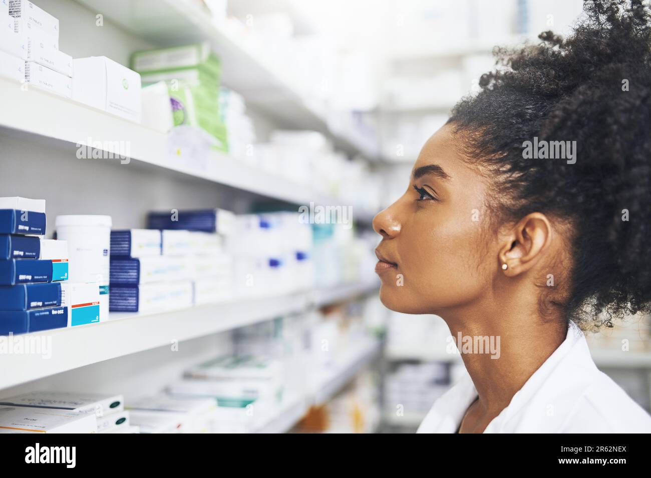 Choosing the right medication for her customer. a female pharmacist ...