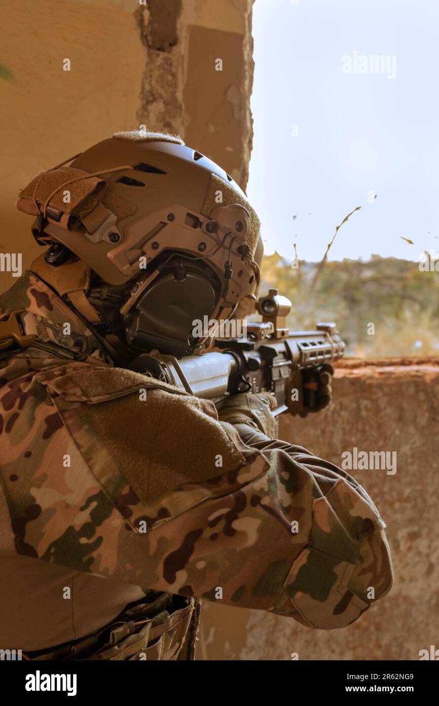 A man wearing a military uniform with a rifle Stock Photo - Alamy