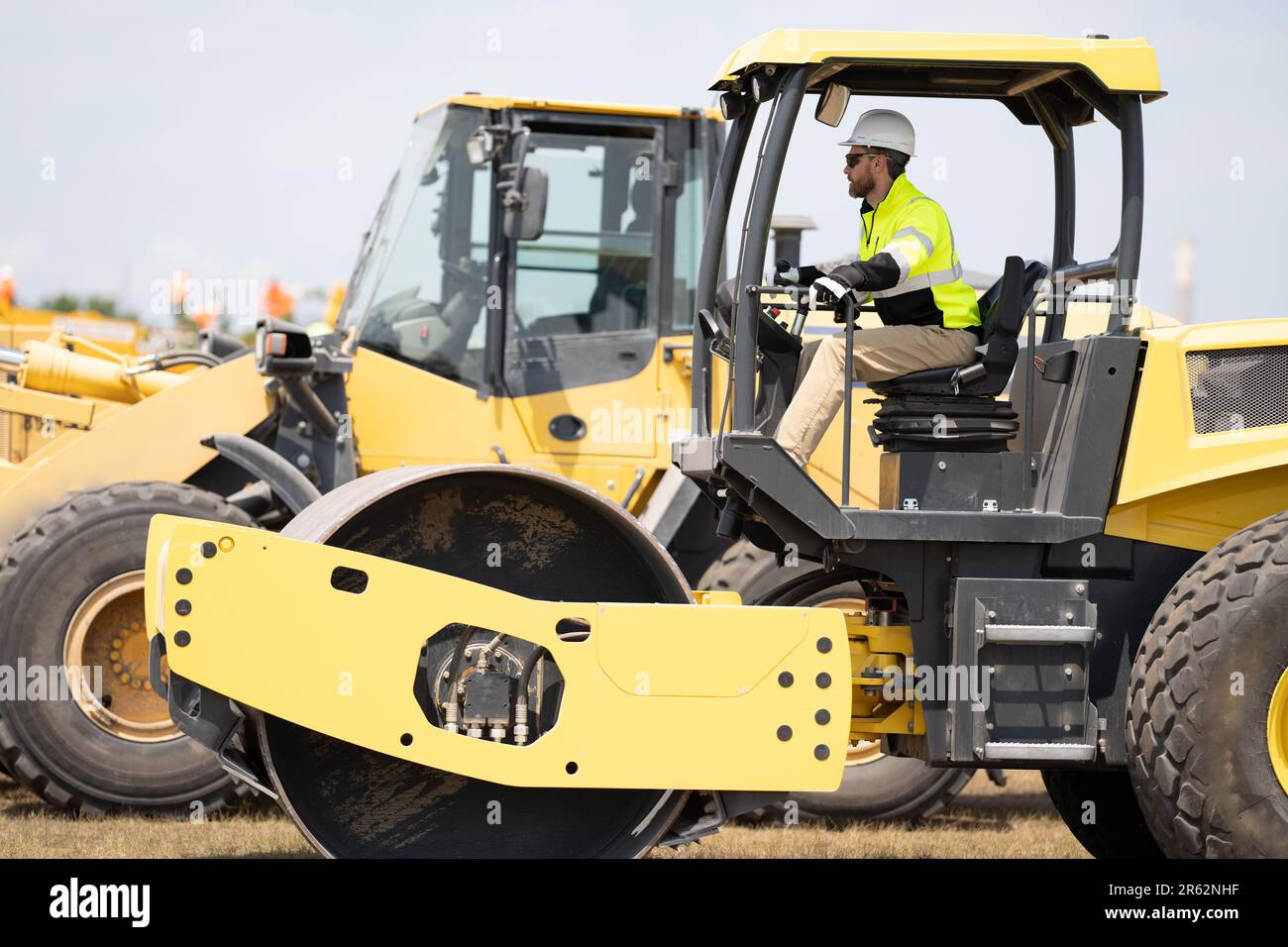 construction worker man drives heavy machinery for roadwork. man worker ...