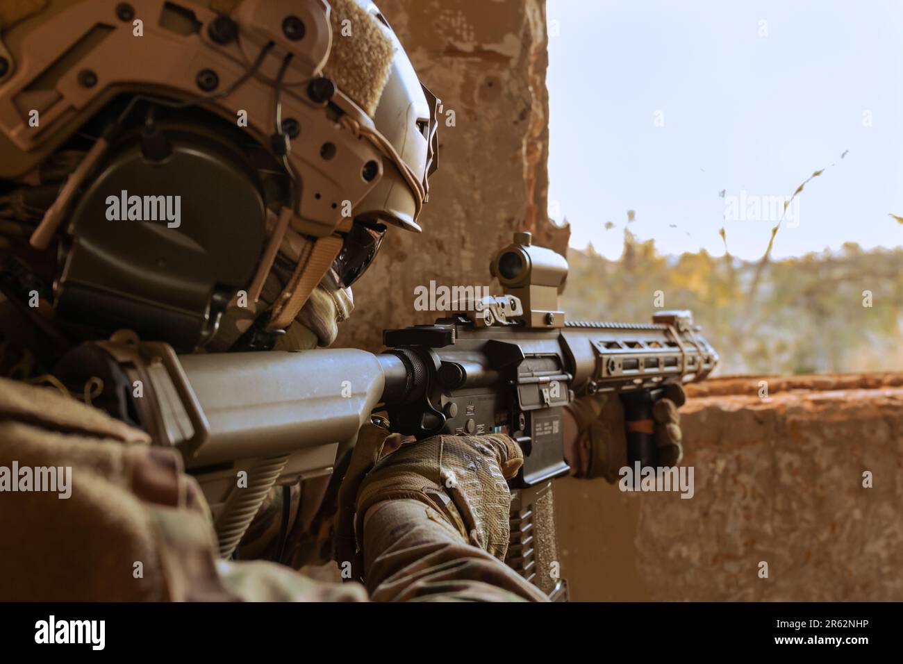 A man wearing a military uniform with a rifle Stock Photo - Alamy