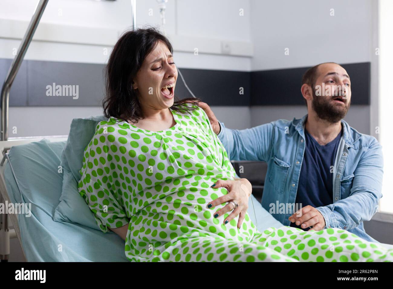 Terrified husband yelling for doctor while pregnant woman having ...