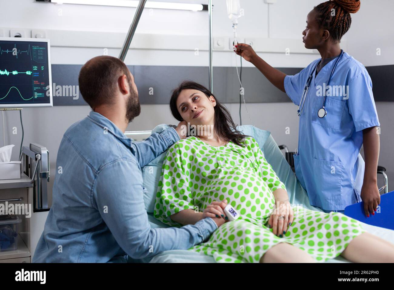 Couple with pregnancy waiting on child delivery in hospital ward ...