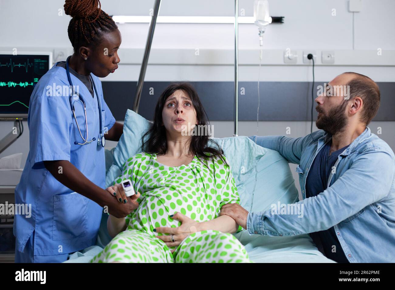 Pregnant woman in labor suffering from painful contractions lying in ...