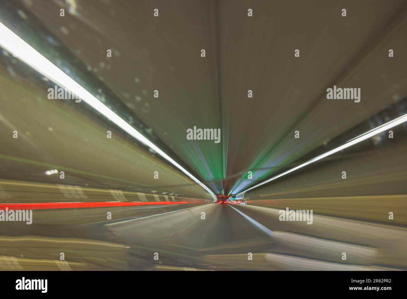 Blurred view of tunnel road from inside of moving vehicle. Abstract ...