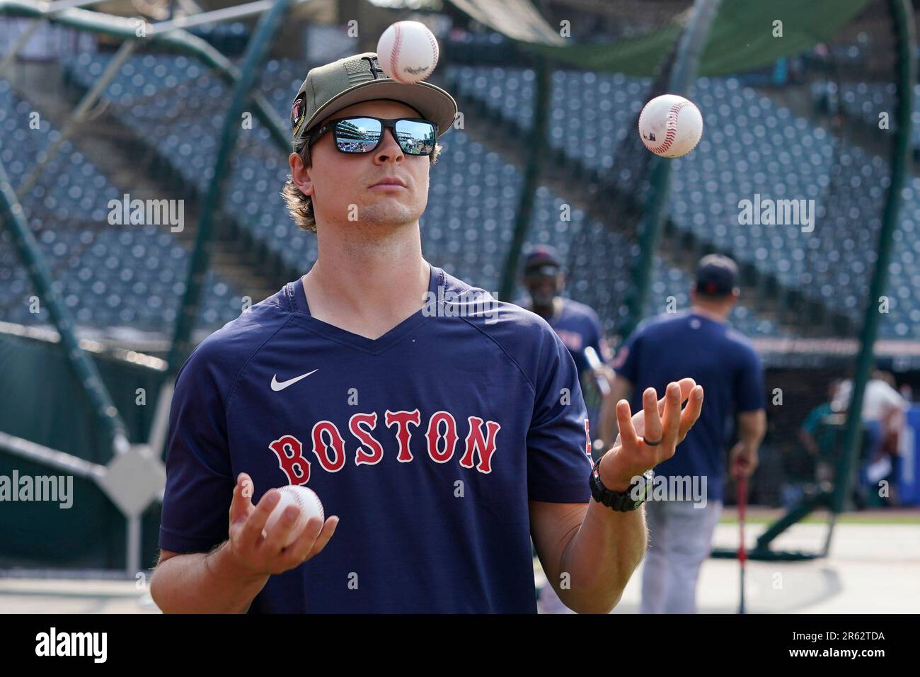 Boston Red Sox bullpen catcher Charlie Madden juggles baseballs during ...