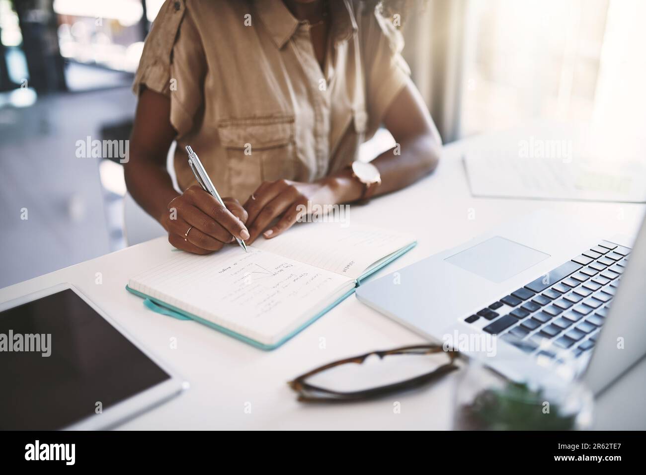 Making strides towards career growth. a young businesswoman writing ...