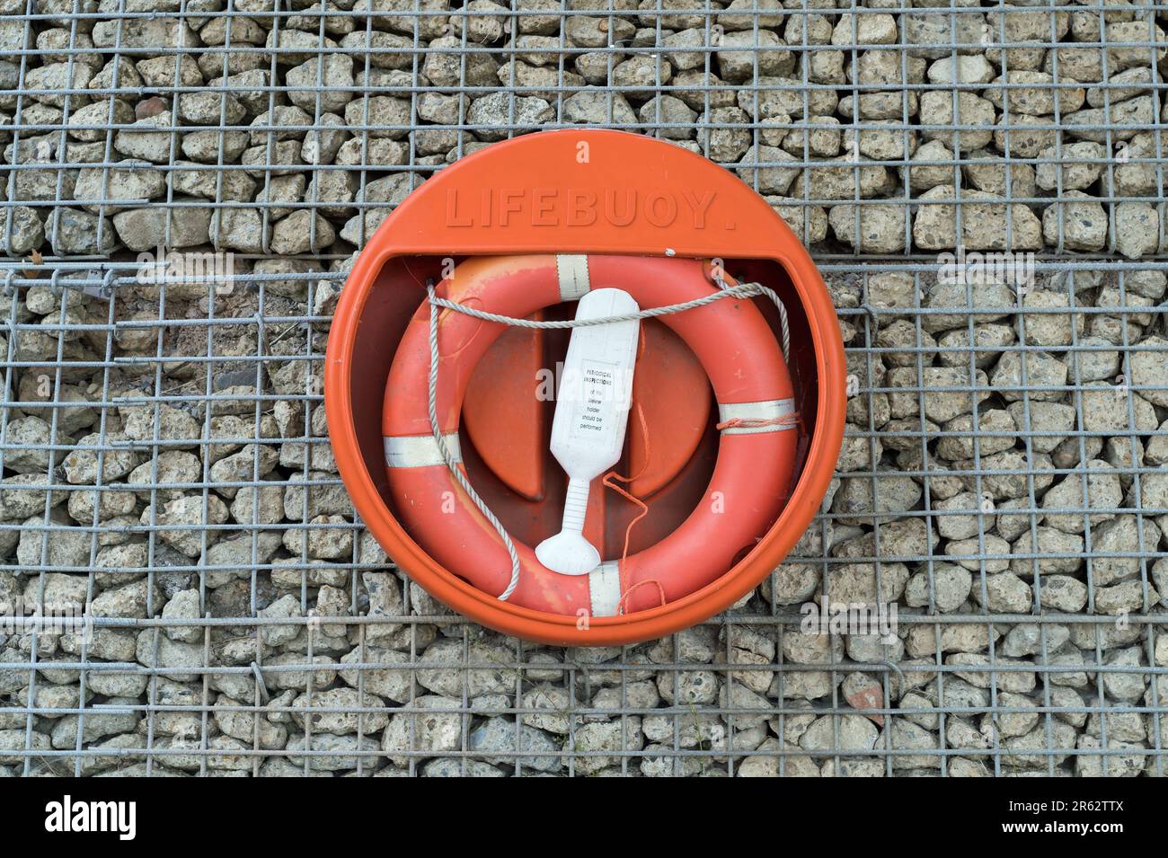 Lifesaving rescue buoy on the brick wall of a canal Stock Photo - Alamy