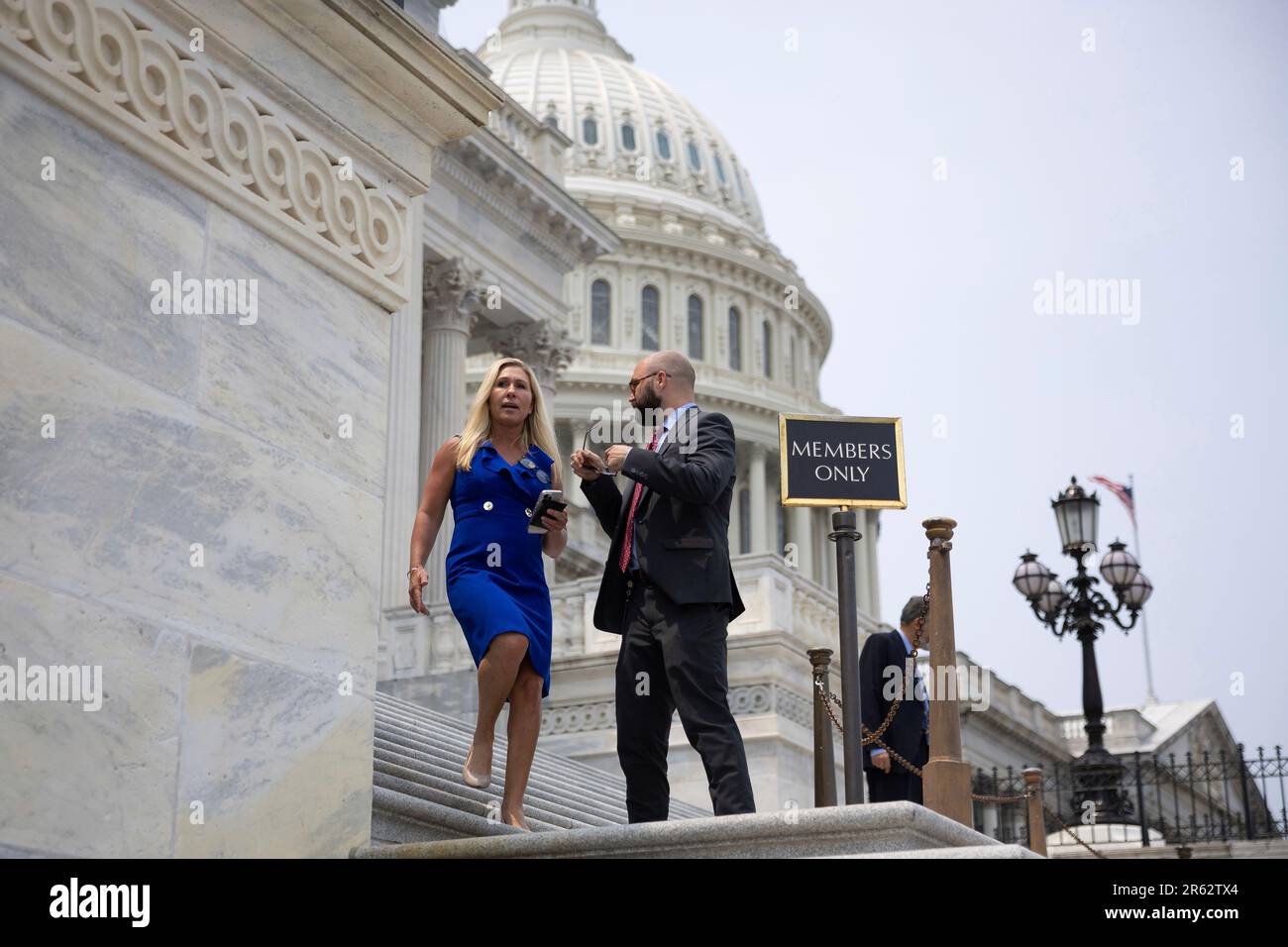 Rep. Marjorie Taylor Greene (R-Ga.) speaks with an aide as she departs ...