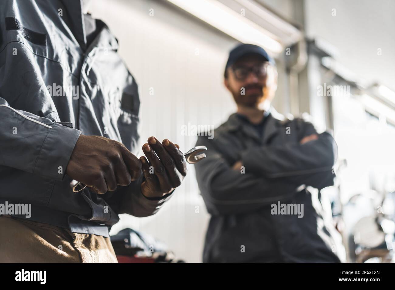 A car mechanic arms holding a wrench. High quality photo Stock Photo ...