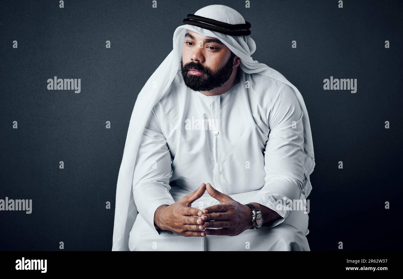 Focused on his success. Studio shot of a young man dressed in Islamic ...