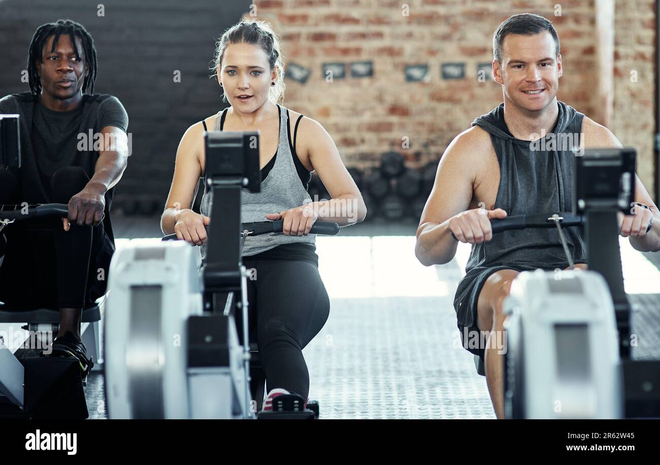 Were closer than weve ever been. a fitness group working out on rowing ...
