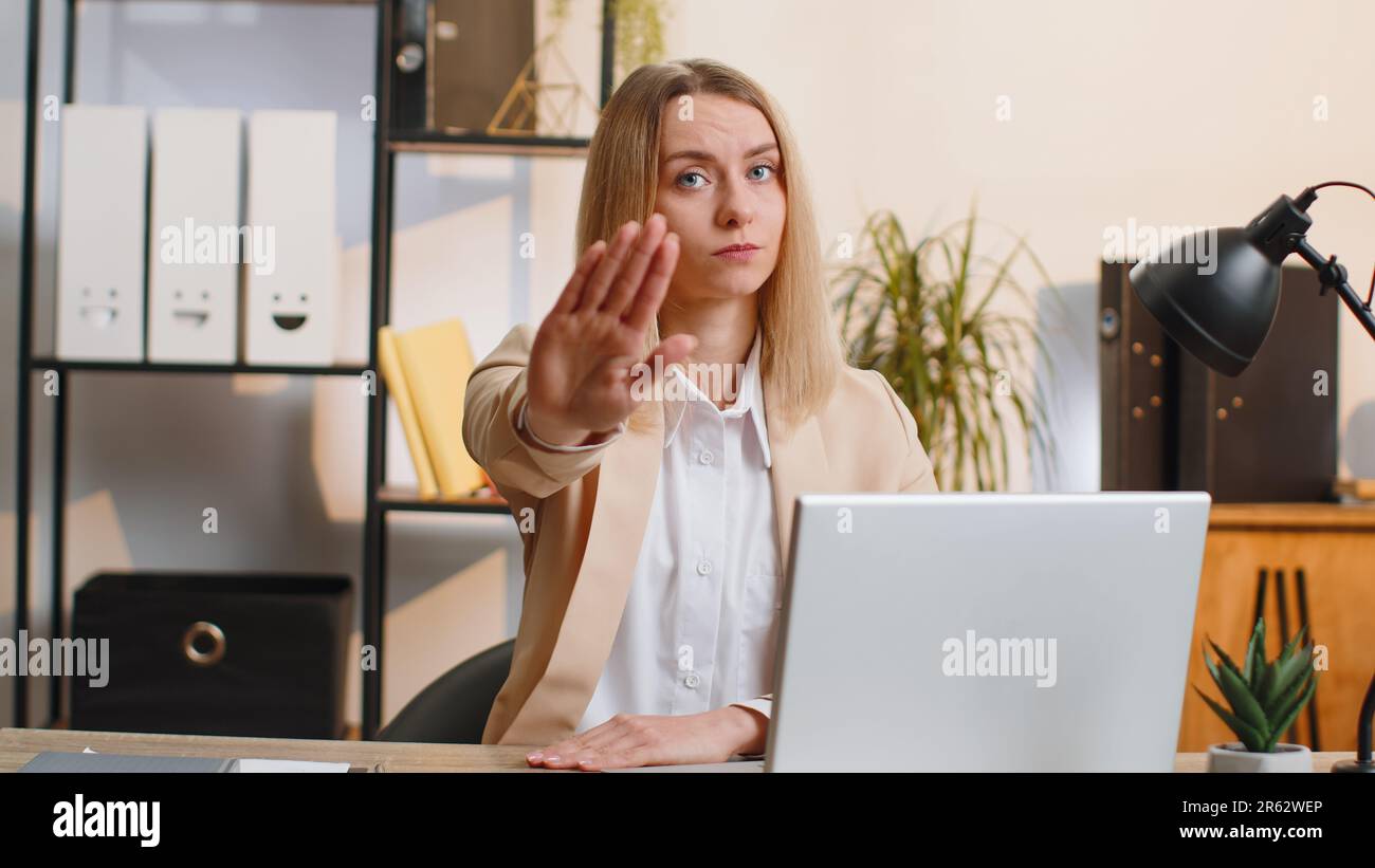 Stop. Young businesswoman girl working on laptop, warning of finish ...