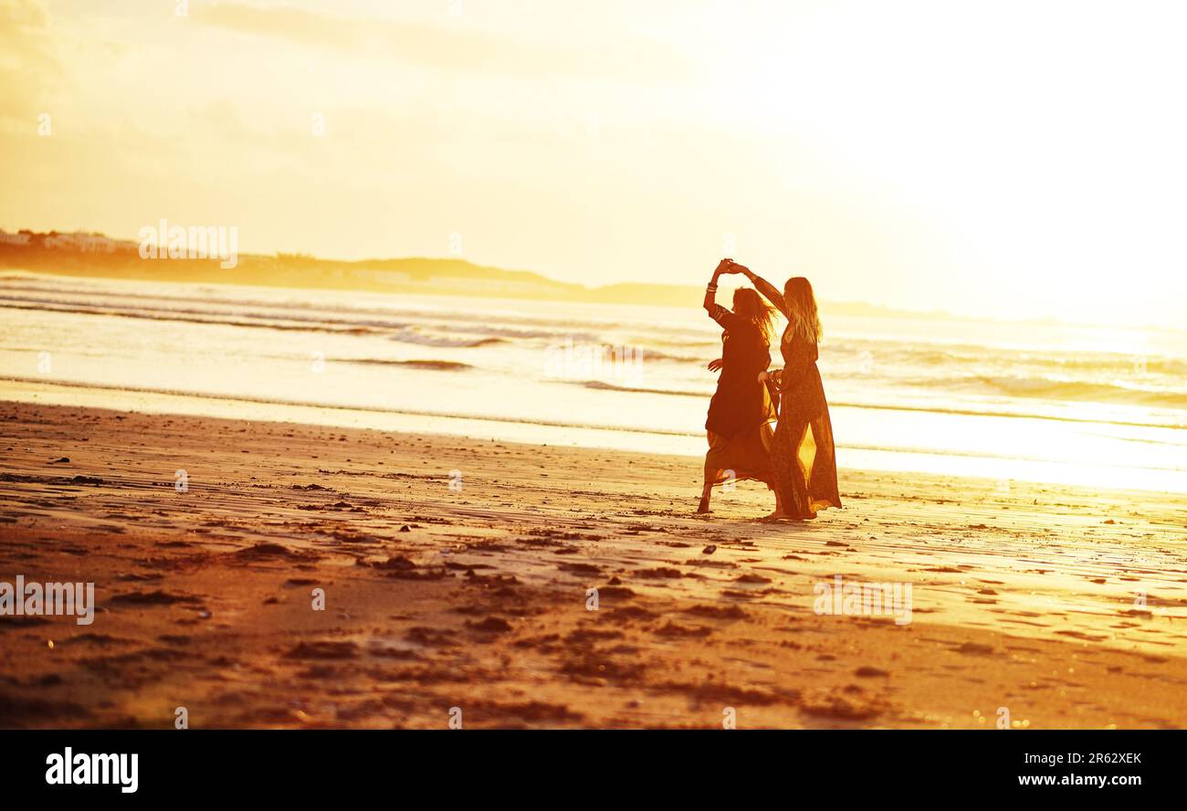 Let us dance in the sun. young people together on the beach Stock Photo ...
