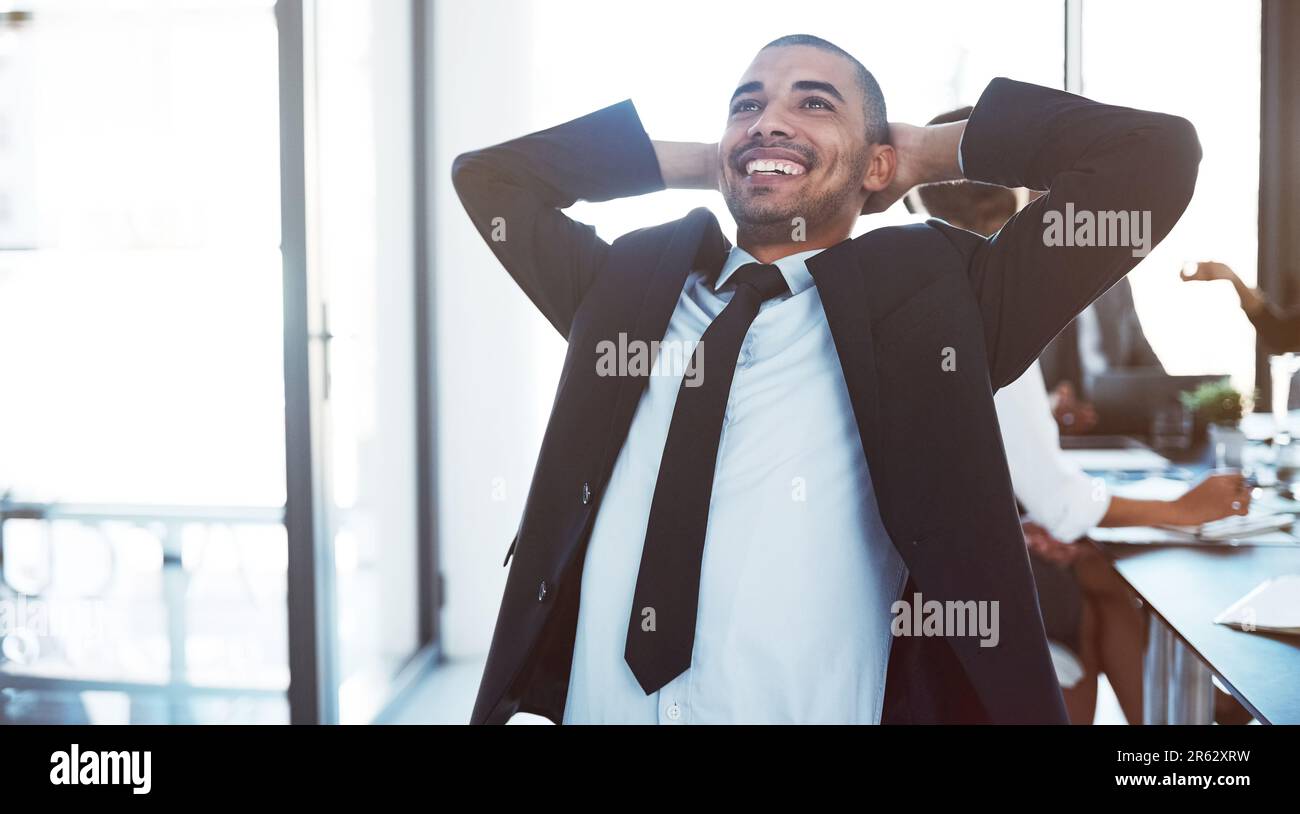 Meeting accomplished. a happy young businessman relaxing during a ...