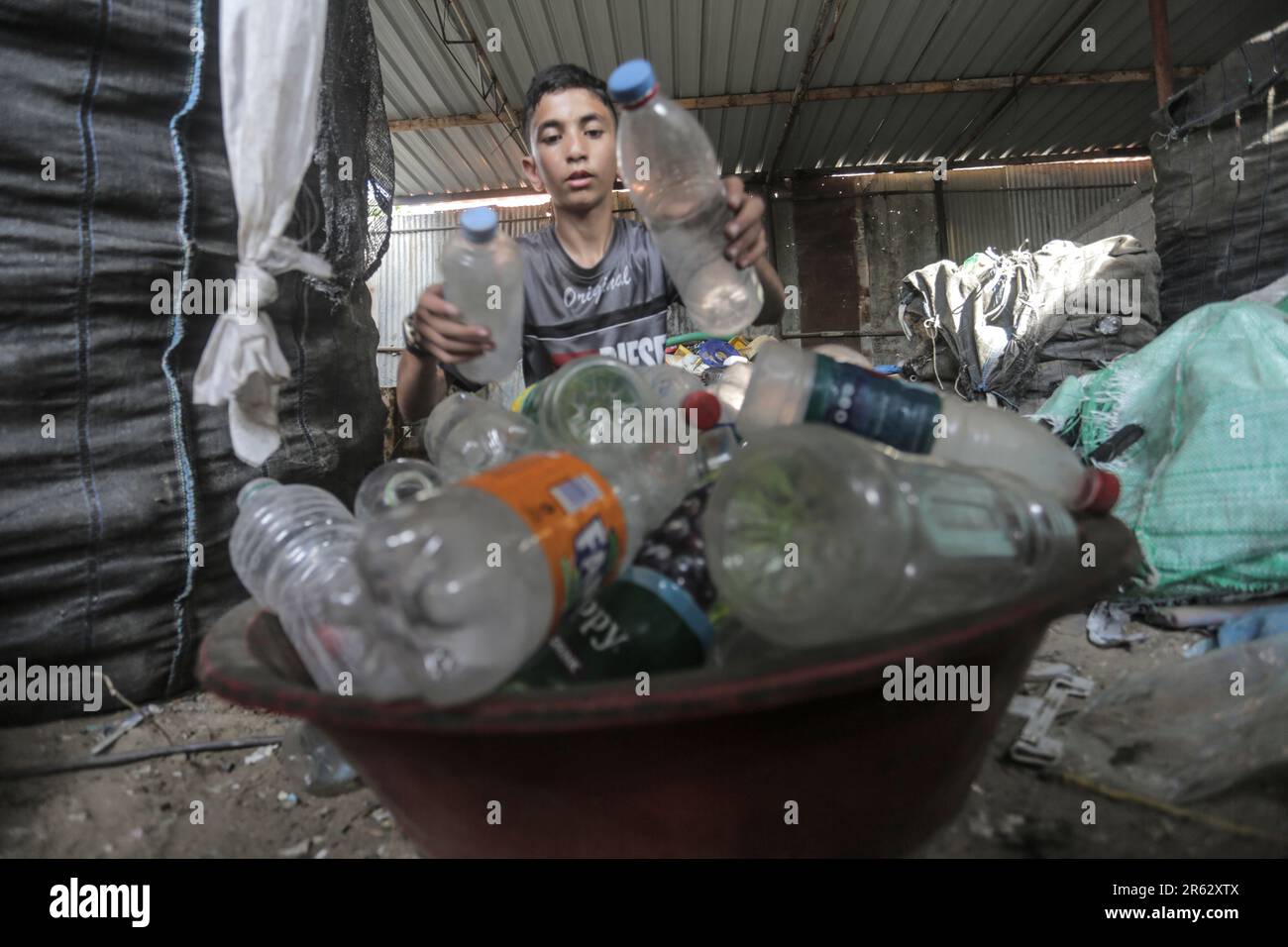 Gaza, Palestine. 06th June, 2023. A Palestinian child picks up plastic ...