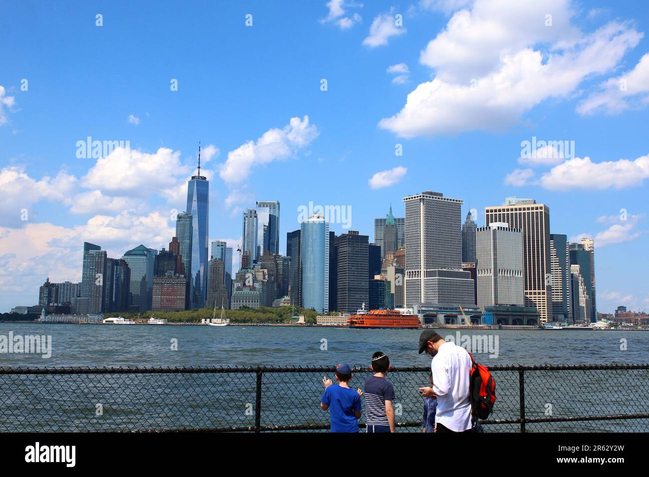 Jewish orthodox family, visitors to Governors Island, overlook New York ...