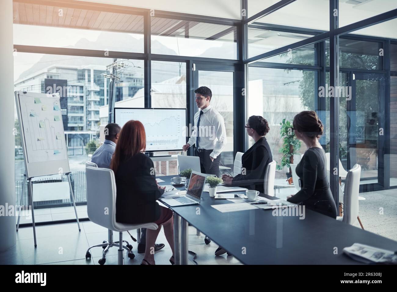 Inside the company boardroom. an executive giving a presentation on a ...