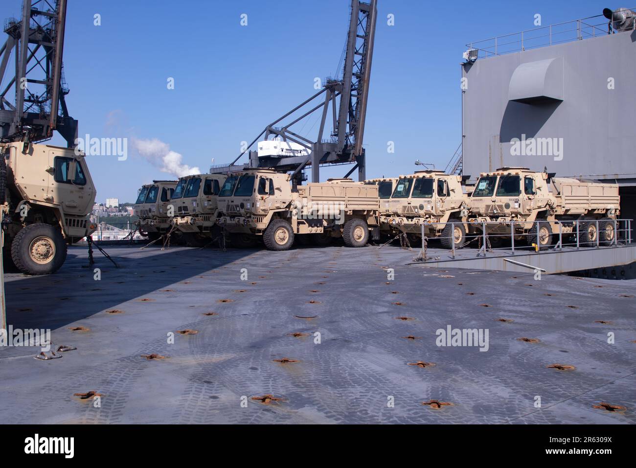 Military vehicles aboard the USNS Bob Hope begin their voyage across ...