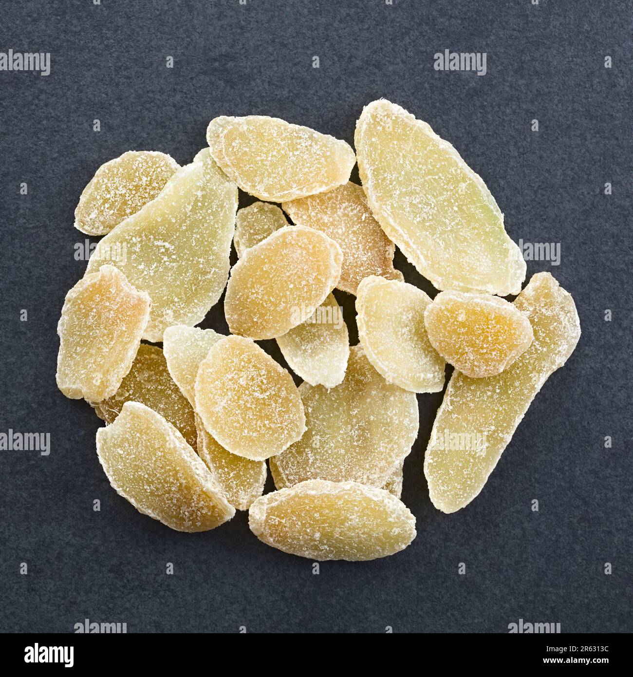 Sweet and spicy candied or crystallized ginger slices photographed ...