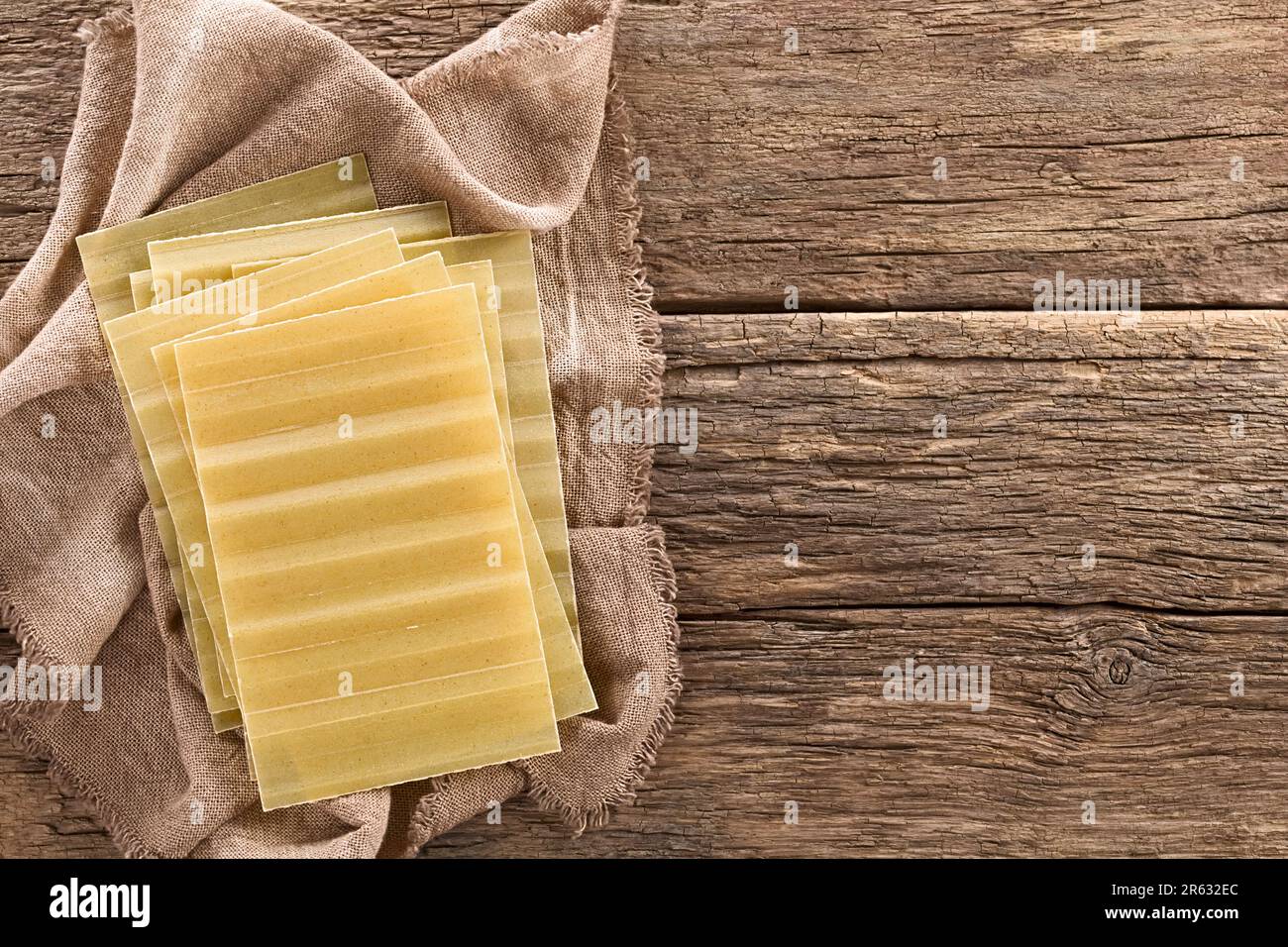Dry uncooked ridged lasagna pasta sheets, photographed overhead on ...