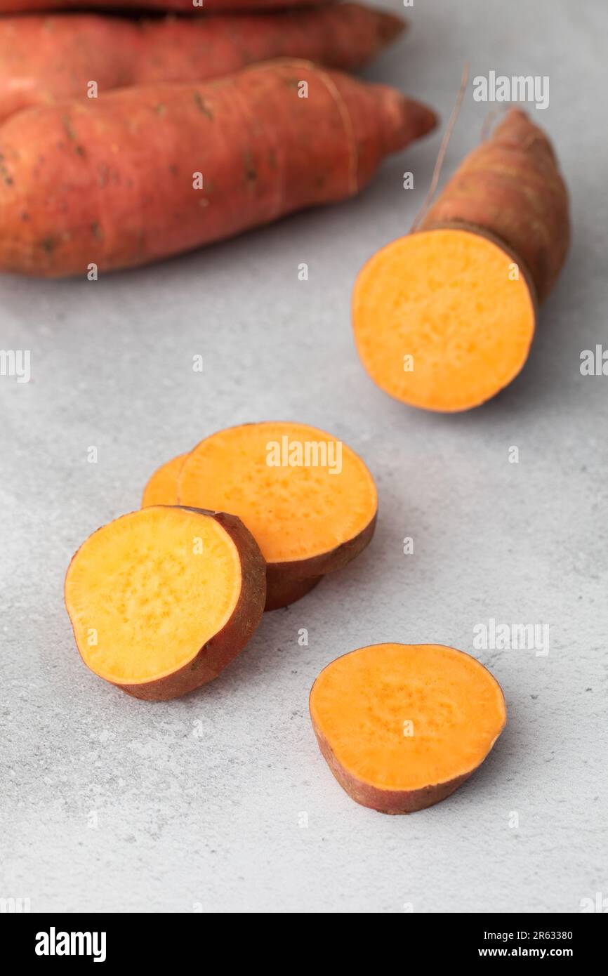 Raw sweet potatoes whole and cut. Orange kumara, sweet potato ...