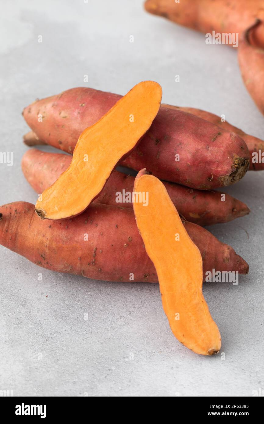 Raw sweet potatoes whole and cut. Orange kumara, sweet potato ...