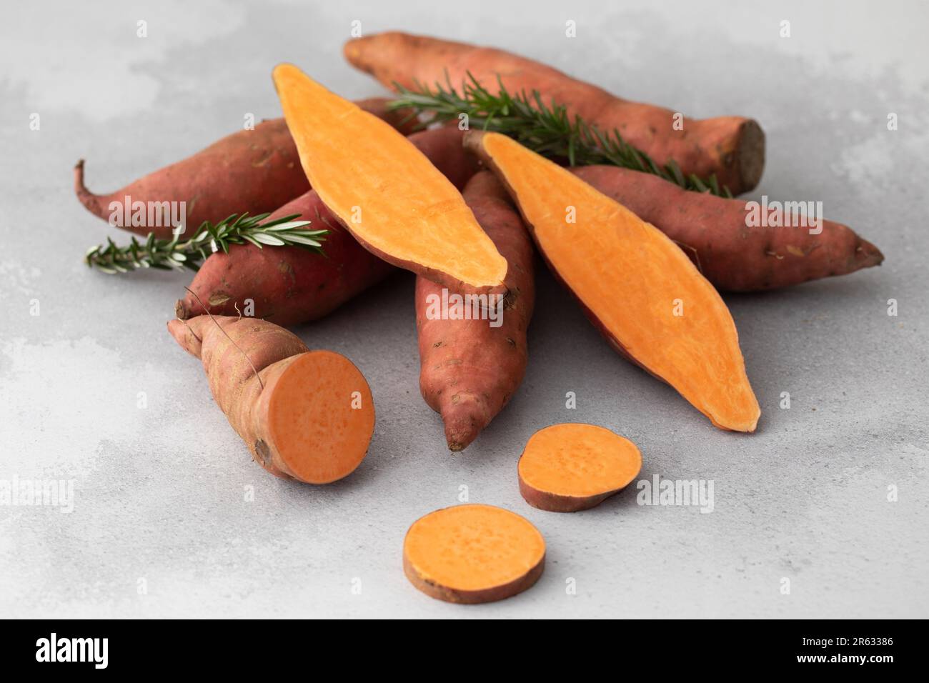 Raw sweet potatoes whole and cut. Orange kumara, sweet potato ...