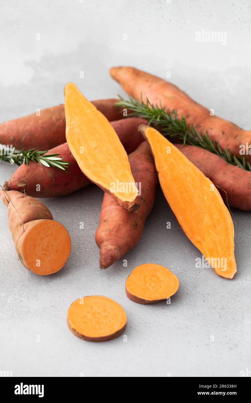 Raw sweet potatoes whole and cut. Orange kumara, sweet potato ...