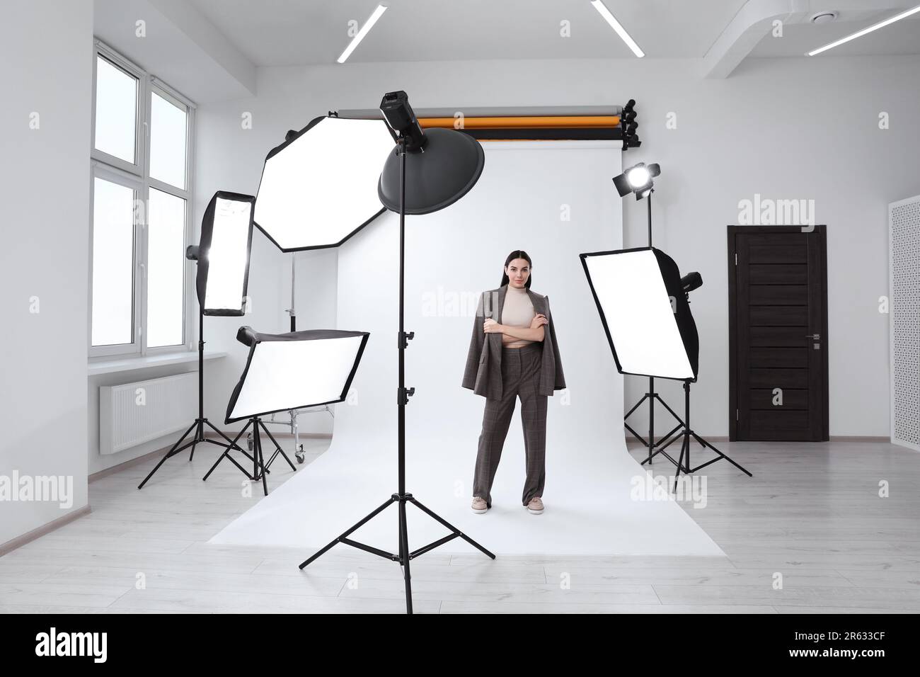 Beautiful young model posing in modern studio. Professional photo ...