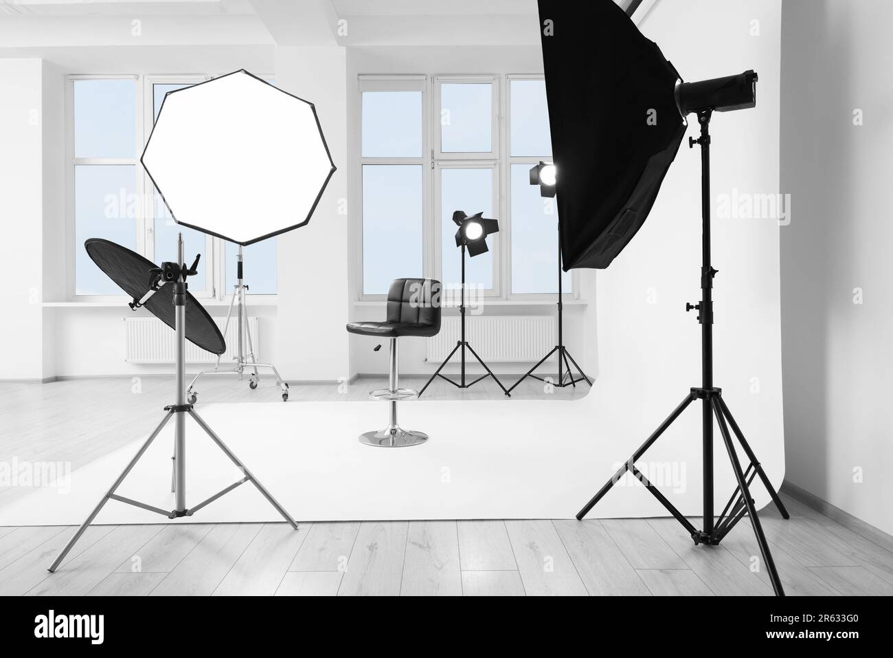 Interior of modern photo studio with bar stool and professional ...