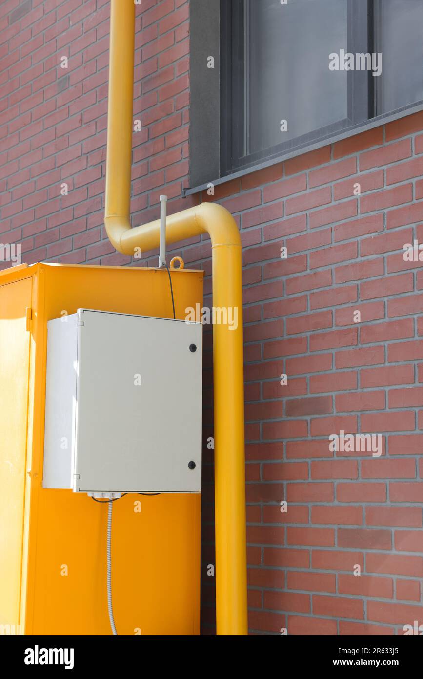 Gas distribution system with pipe near red brick wall outdoors Stock ...