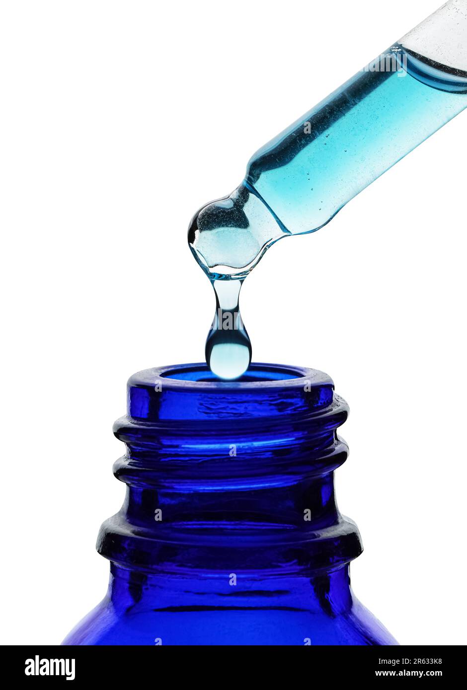 Dripping light blue facial serum from pipette into glass bottle on ...