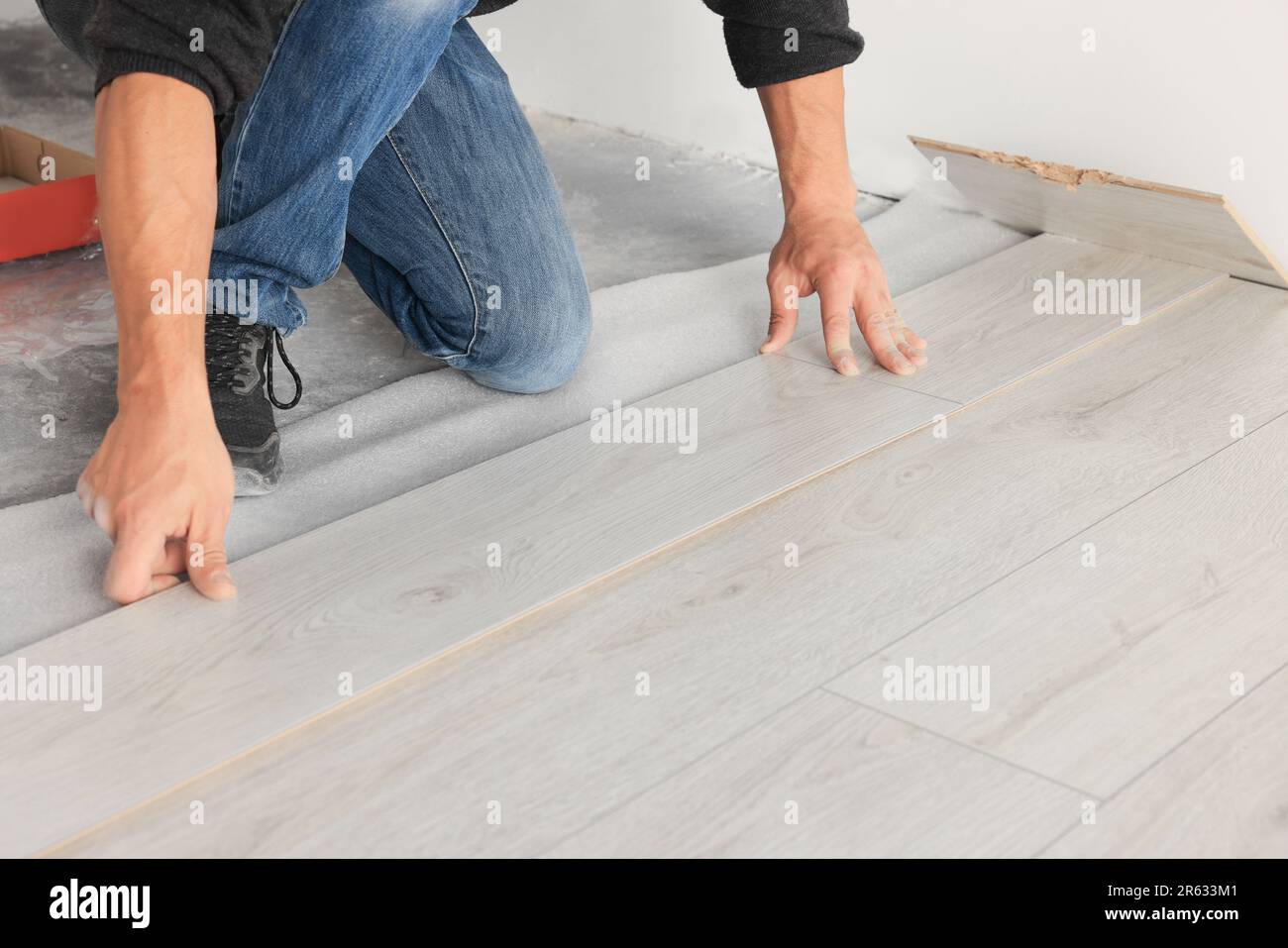 Professional worker installing new laminate flooring, closeup Stock Photo - Alamy