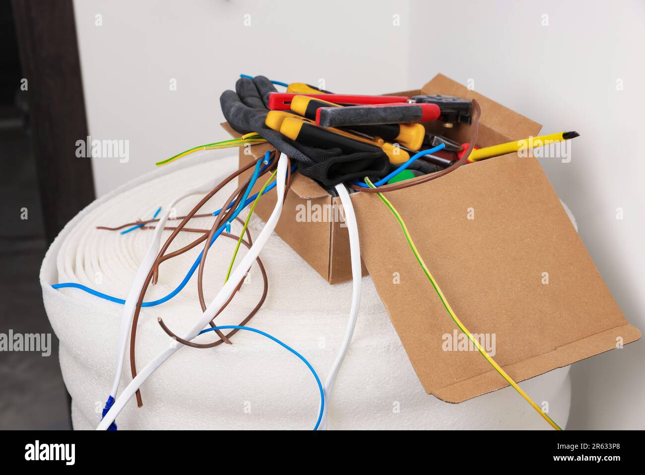 Different tools and cables in paper indoors. Installation of electrical ...