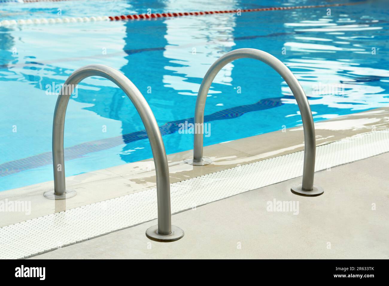Ladder with handrails in outdoor swimming pool Stock Photo - Alamy
