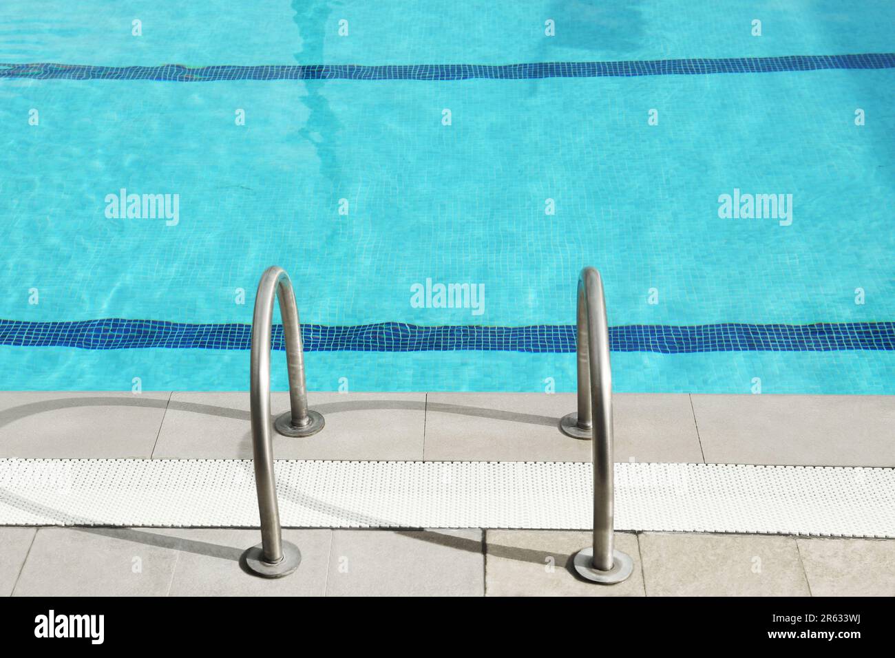 Ladder with handrails in outdoor swimming pool Stock Photo - Alamy