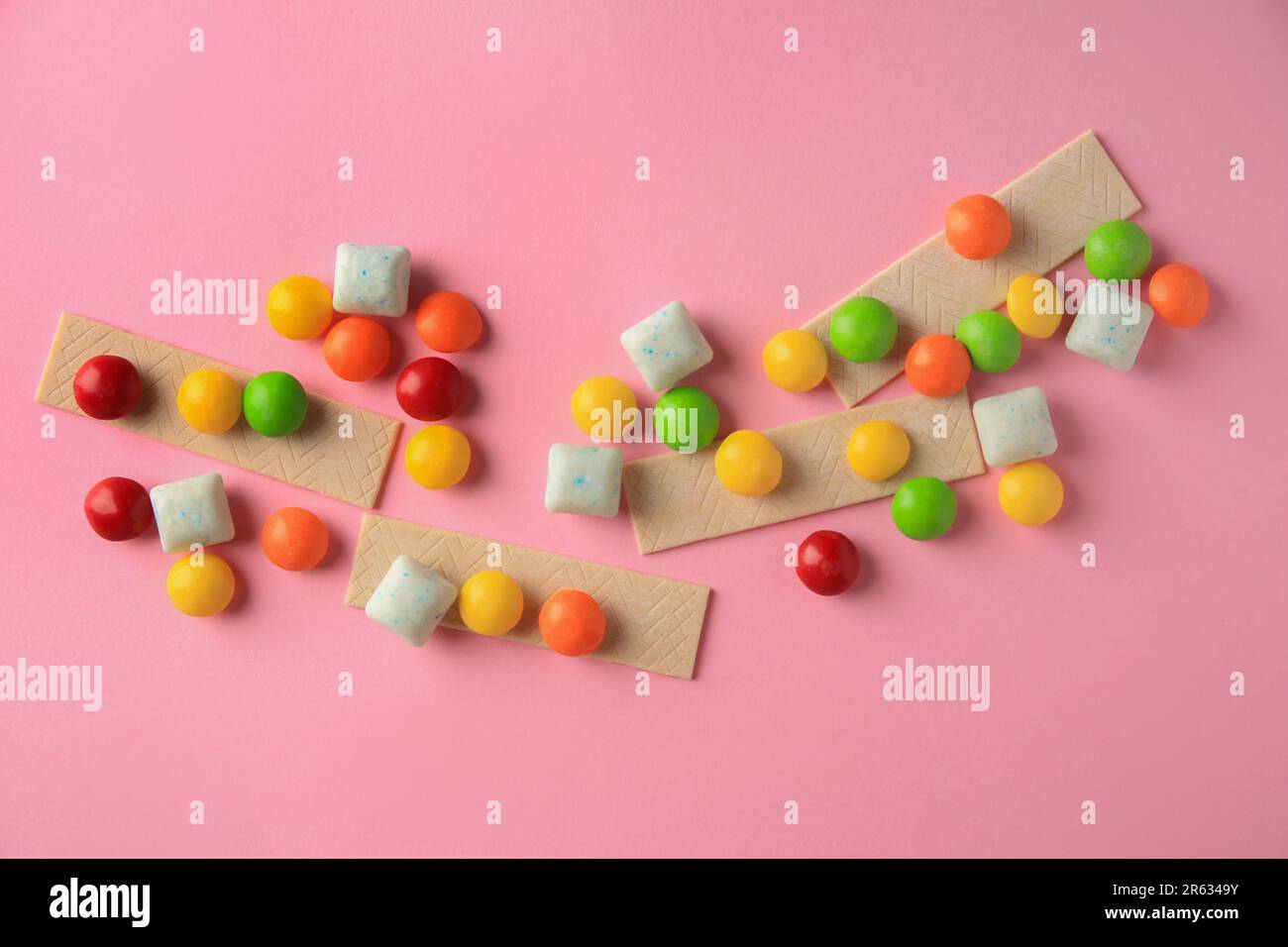 Different tasty chewing gums on pink background, flat lay Stock Photo ...