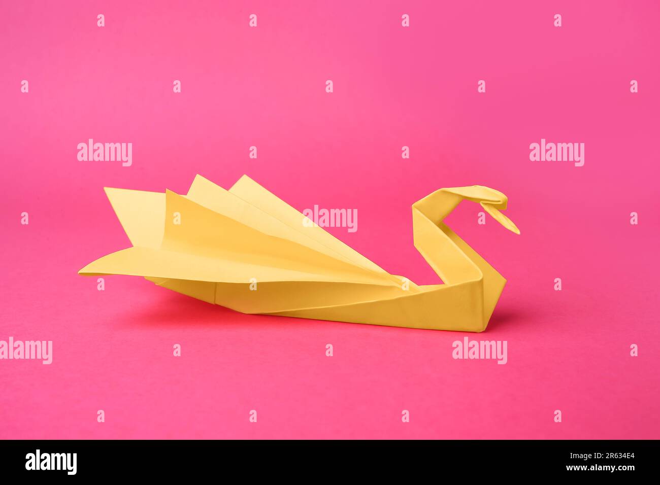 Yellow paper swan on pink background. Origami art Stock Photo - Alamy