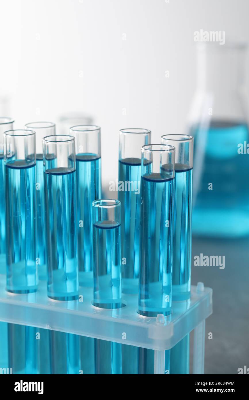 Test tubes with light blue liquid in laboratory, closeup Stock Photo ...
