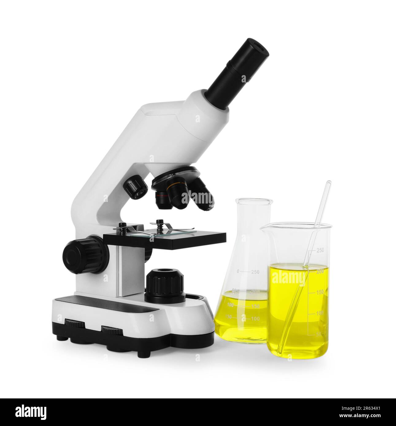Laboratory glassware with yellow liquid and microscope isolated on ...