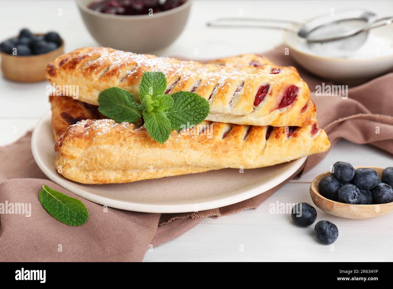 Fresh tasty puff pastry with sugar powder, mint and blueberries on ...