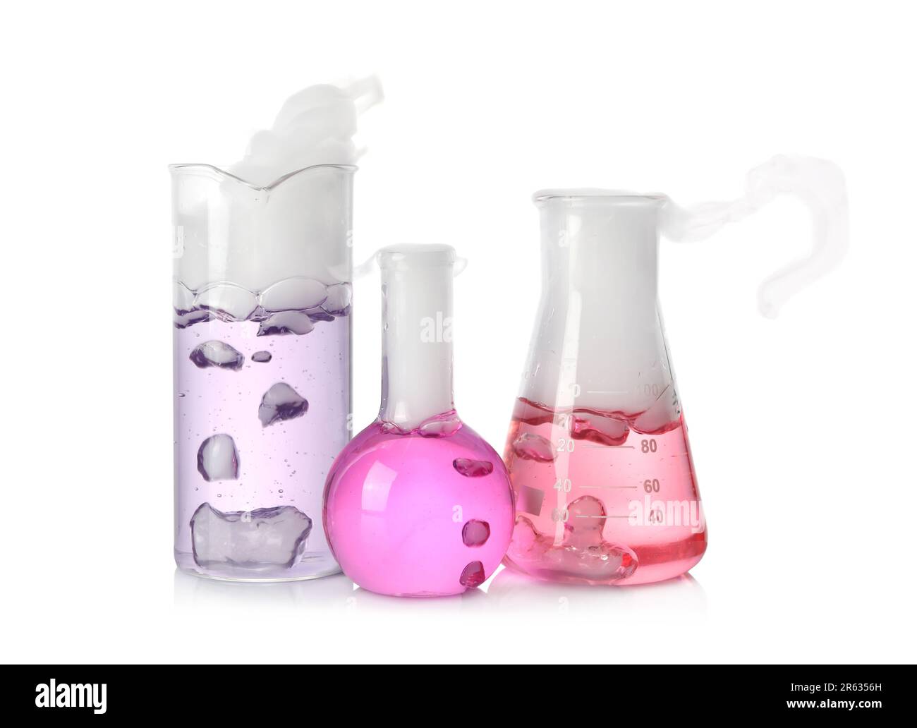 Laboratory glassware with colorful liquids and steam isolated on white ...