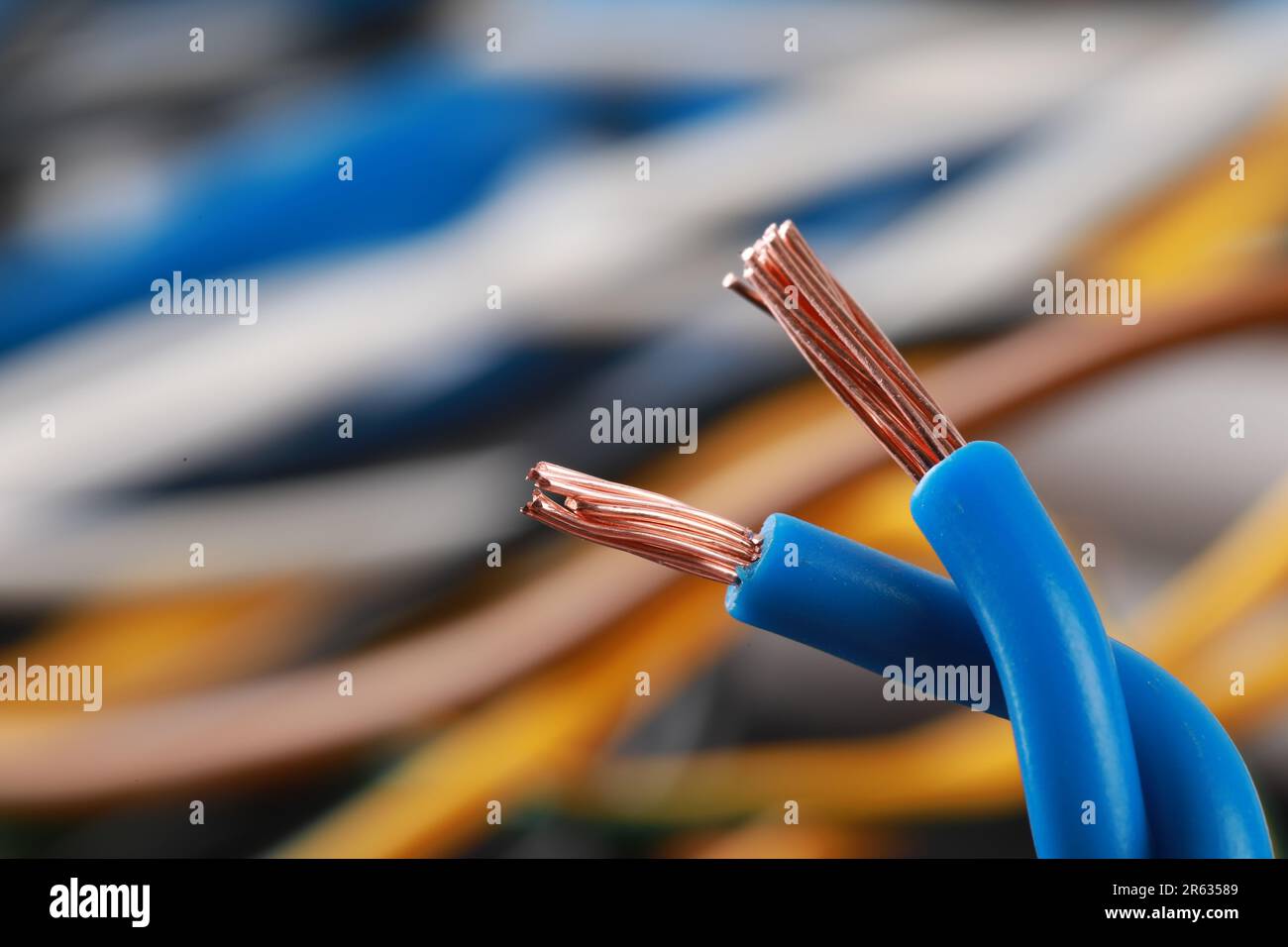 Light blue electrical wire on blurred background, closeup. Space for ...