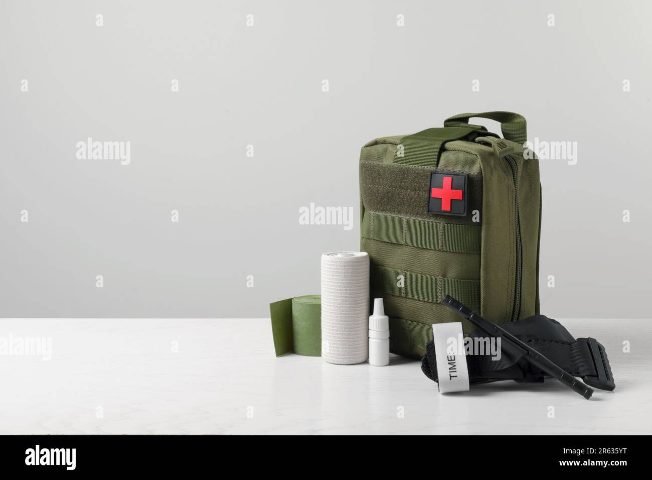 Military first aid kit, tourniquet, drops and elastic bandage on white ...