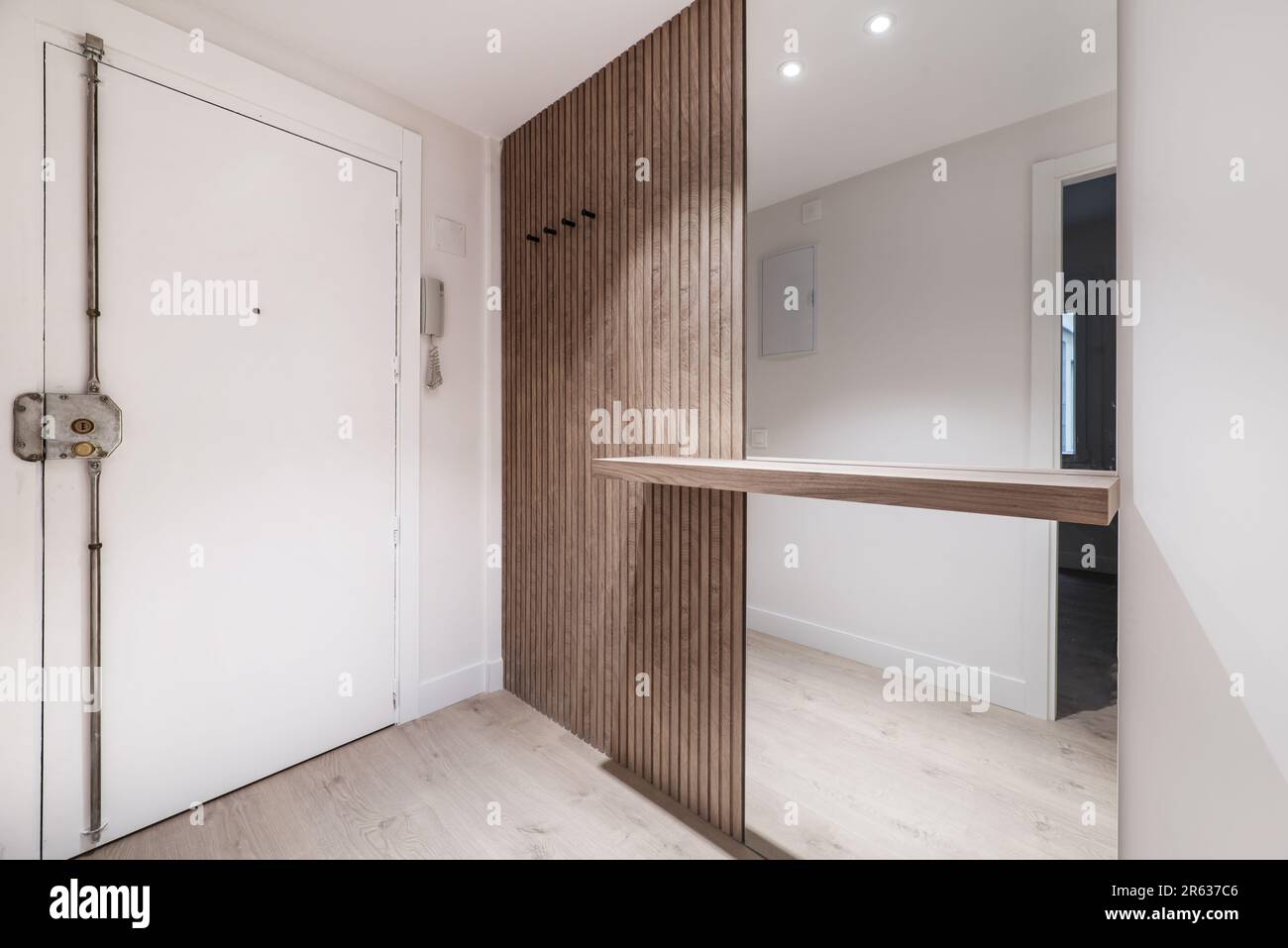 Entrance hall of a house with a white wooden access door and a ...