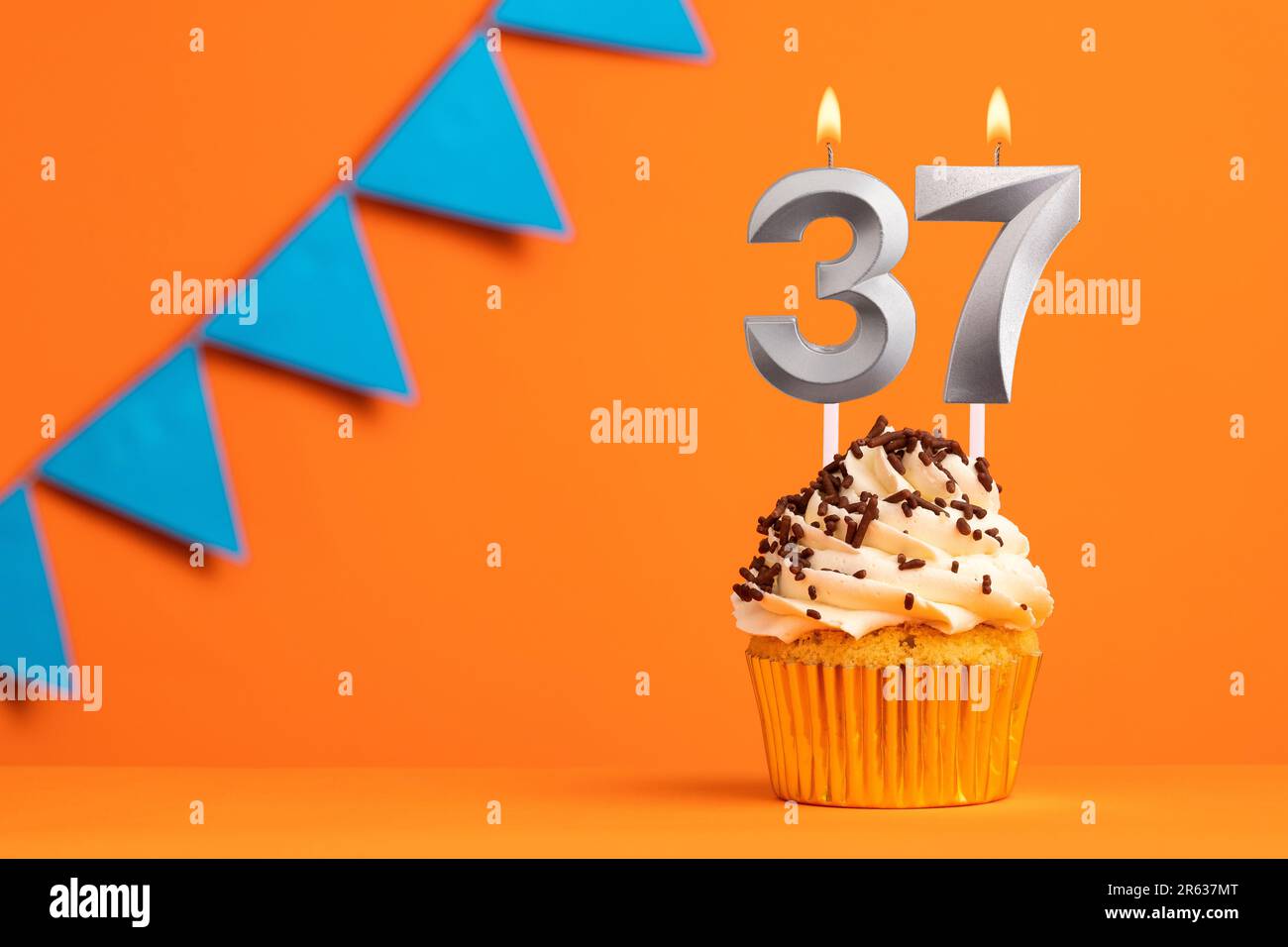 Candle number 37 - Cake birthday in orange background Stock Photo - Alamy